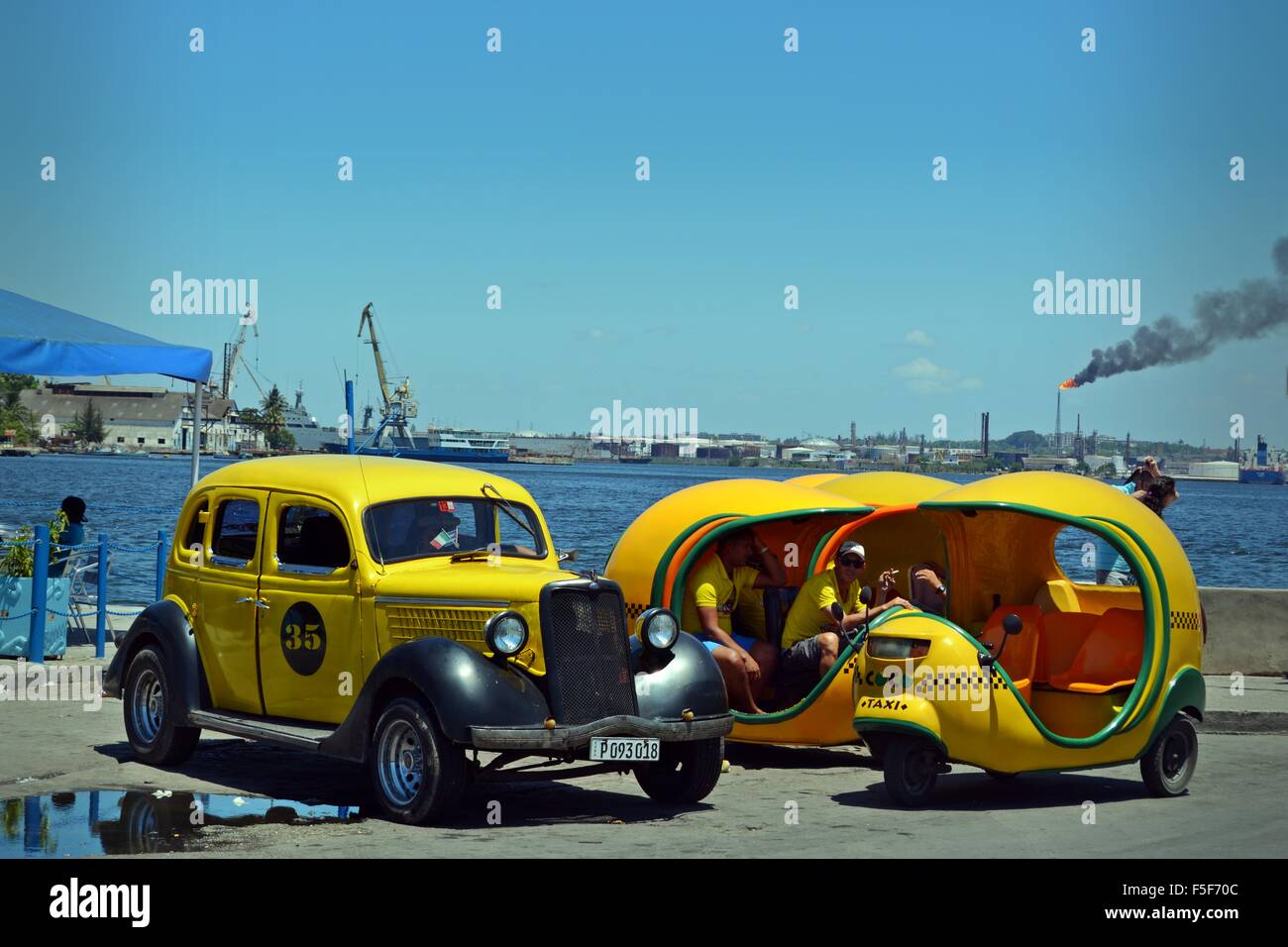 yellow Cuban coco taxis and vintage cab parked on the waterfront in ...