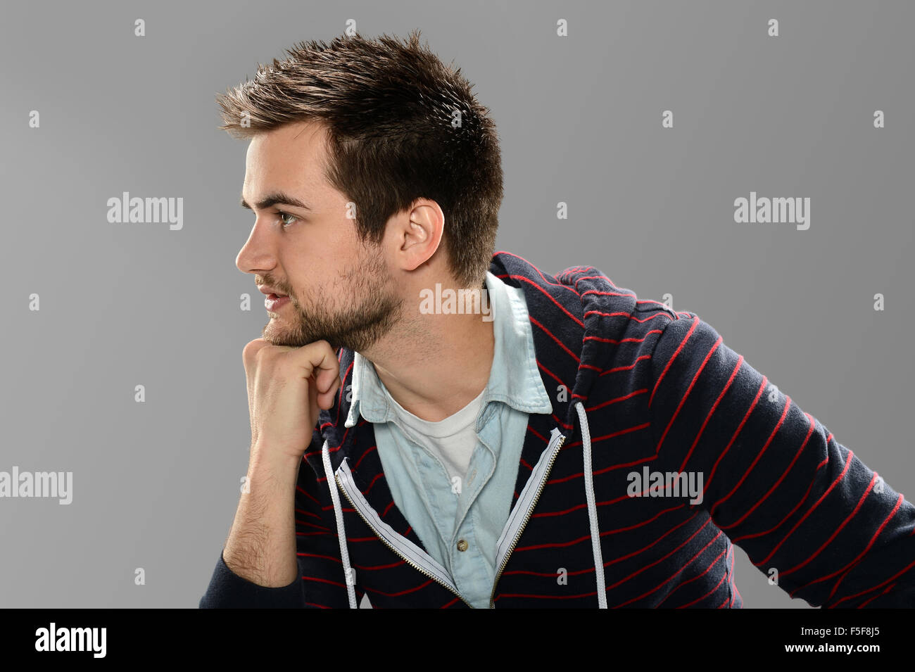 Profile of young man thinking isolated over gray background Stock Photo ...