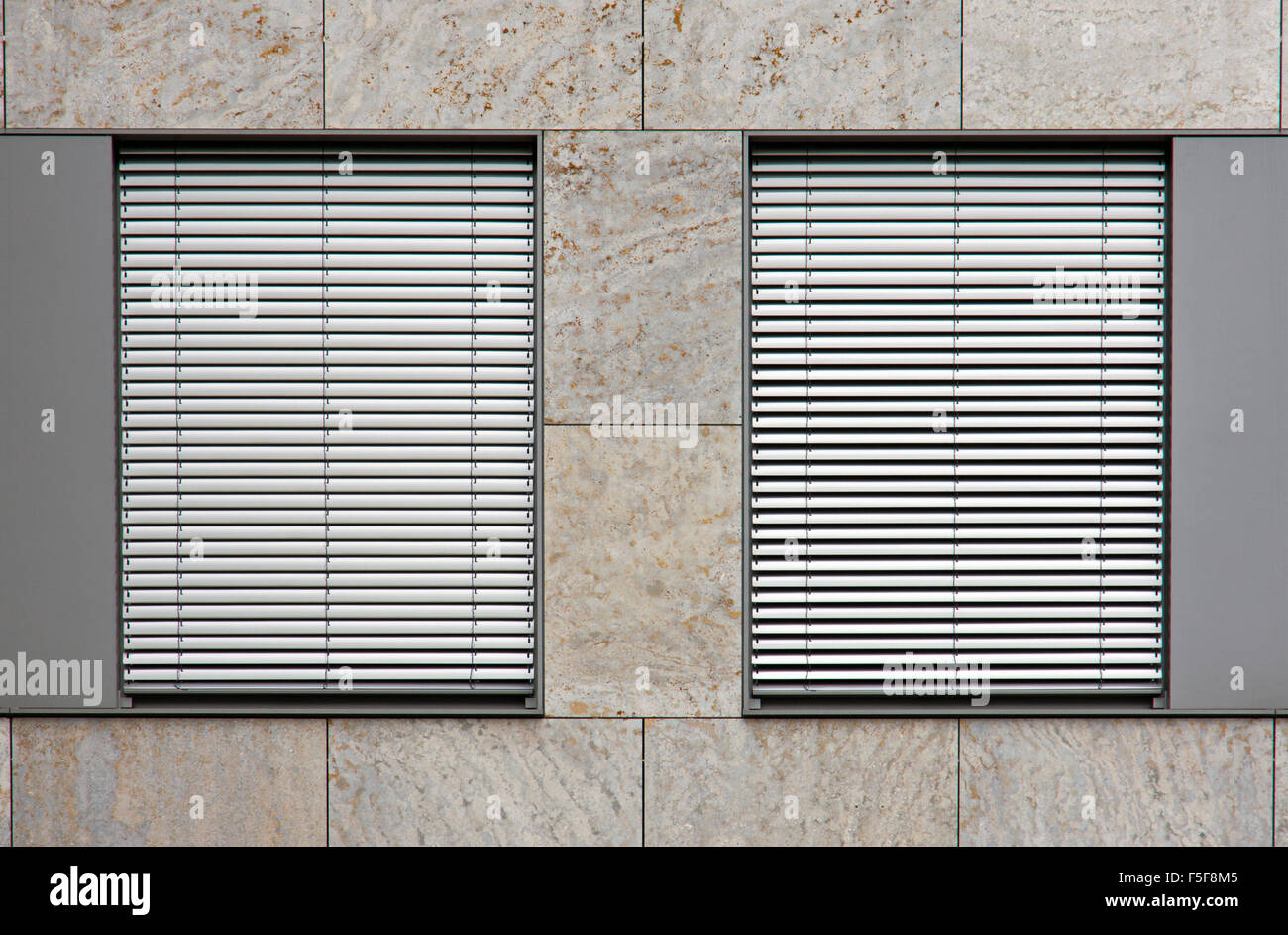 Two windows with silver shutters Stock Photo - Alamy