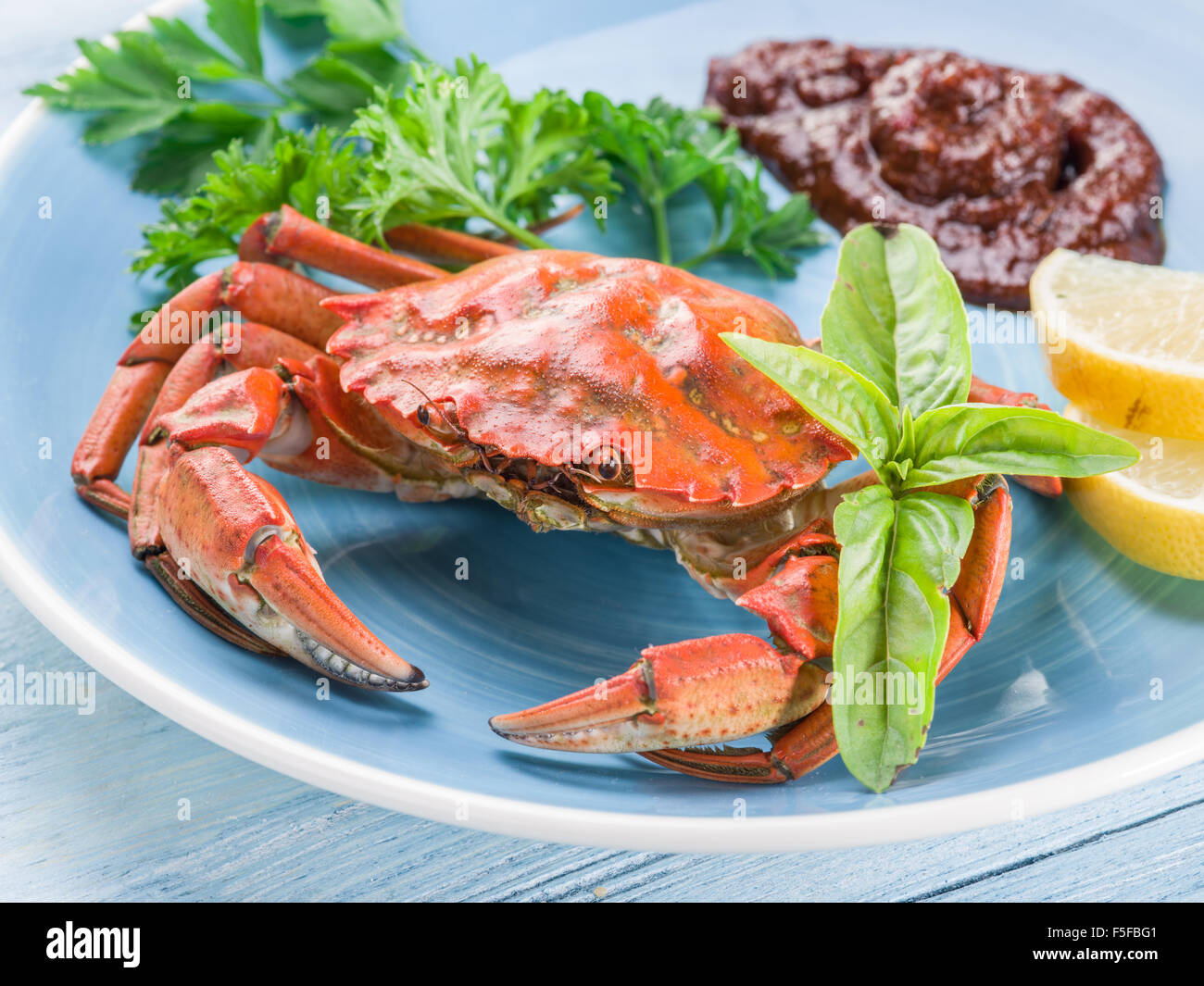 Seafood dish - cooked crab with lemon and herbs Stock Photo - Alamy