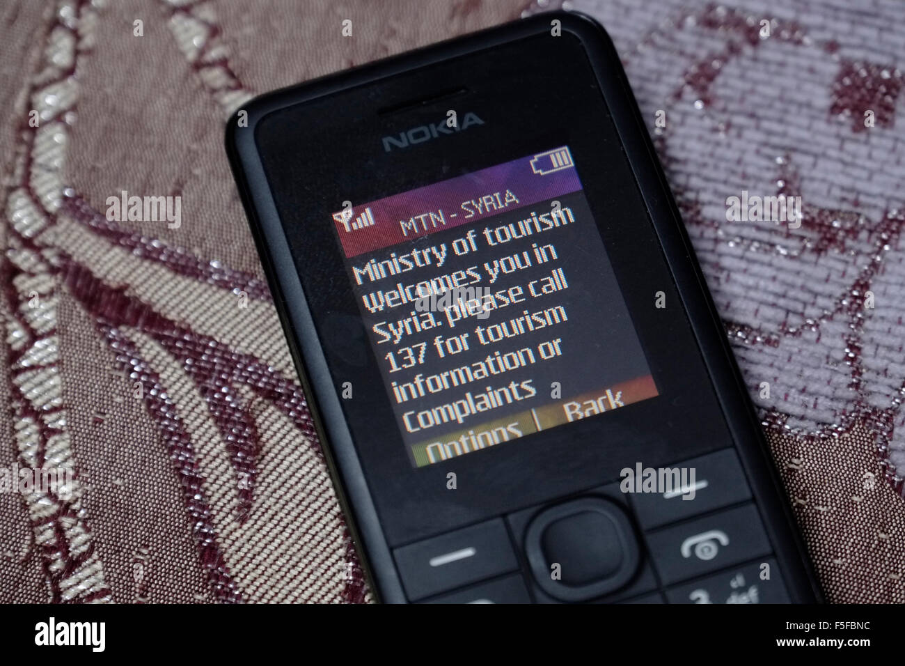A screen of a cellphone shows a greeting message from the Syrian ...