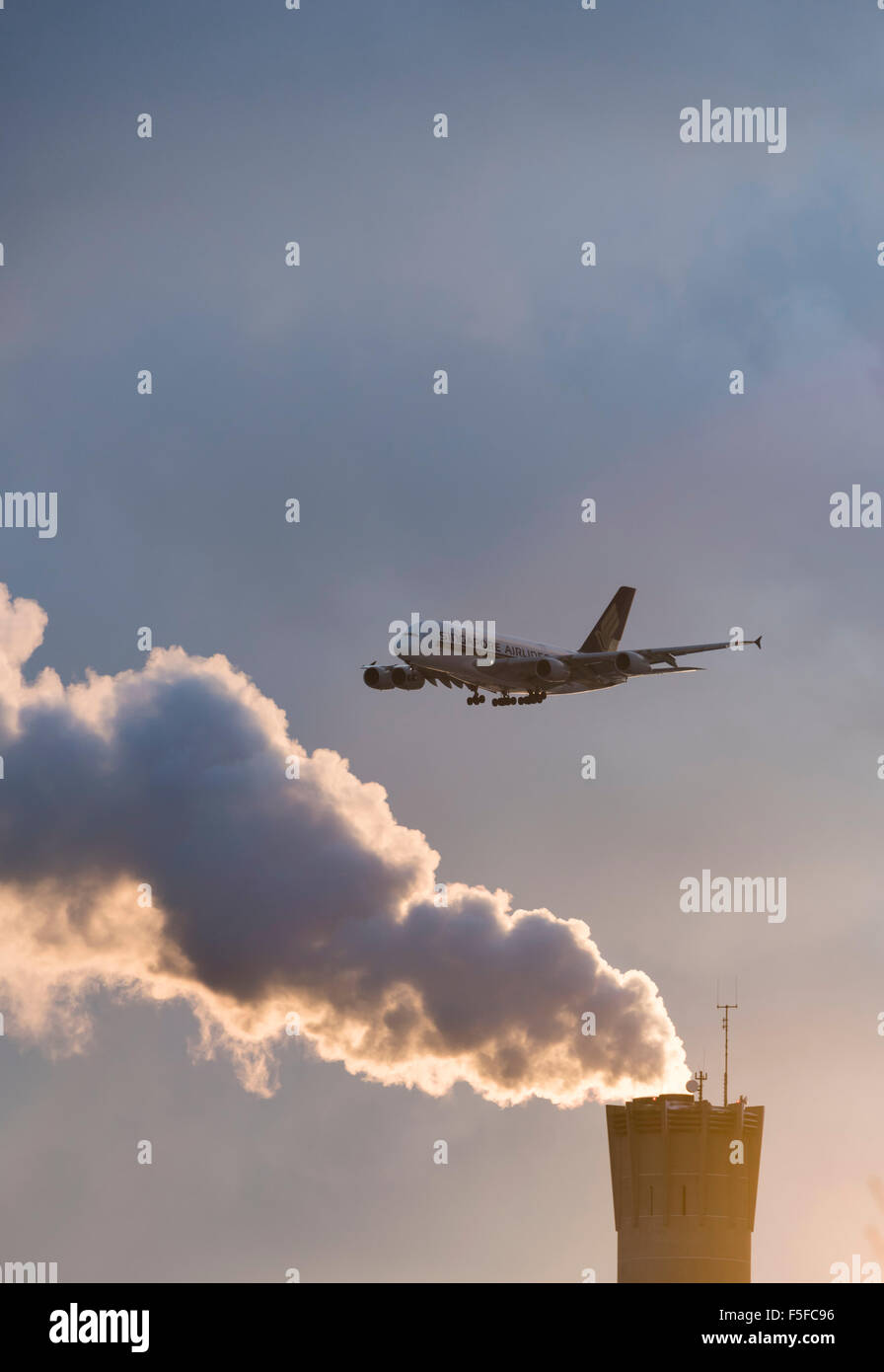 Dense smoke is leaving a smoke stack of a power plant while in the ...