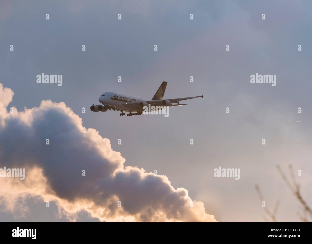 Dense smoke is leaving a smoke stack of a power plant while in the ...
