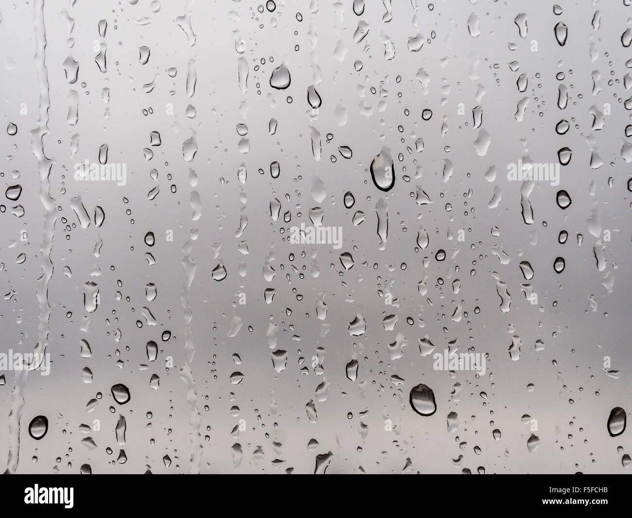 Raindrops trickle down glass hi-res stock photography and images - Alamy