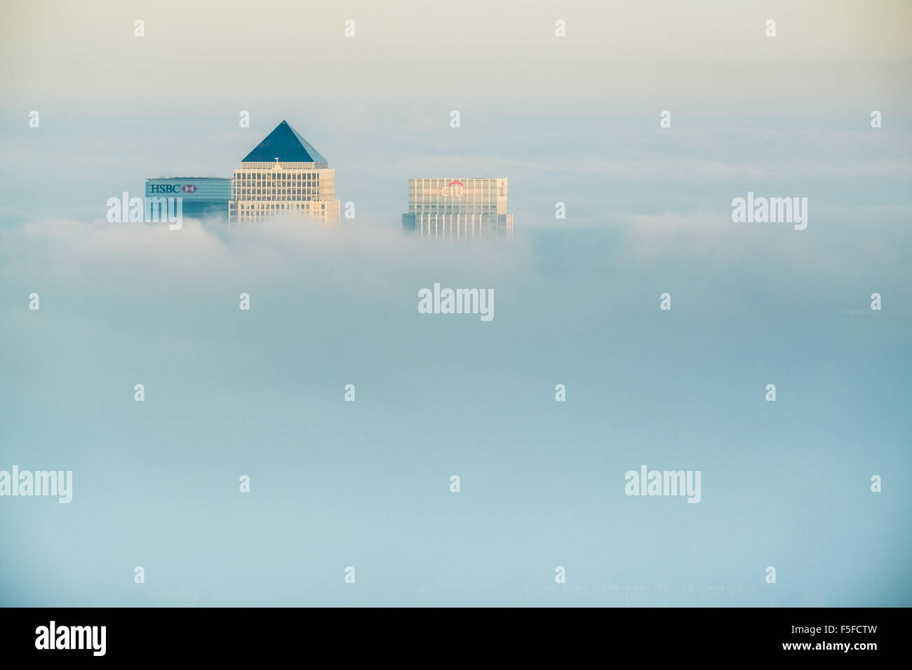 The roof tops of docklands high rise buildings protruding through the ...