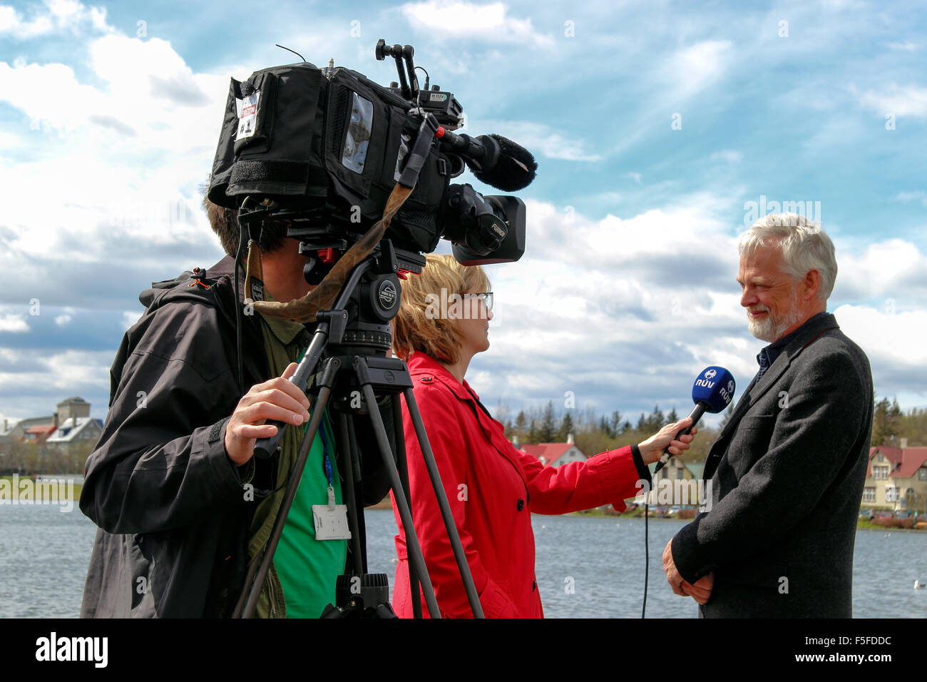 Man being interviewed on camera at Tjörnin lake Reykjavik Iceland Stock ...