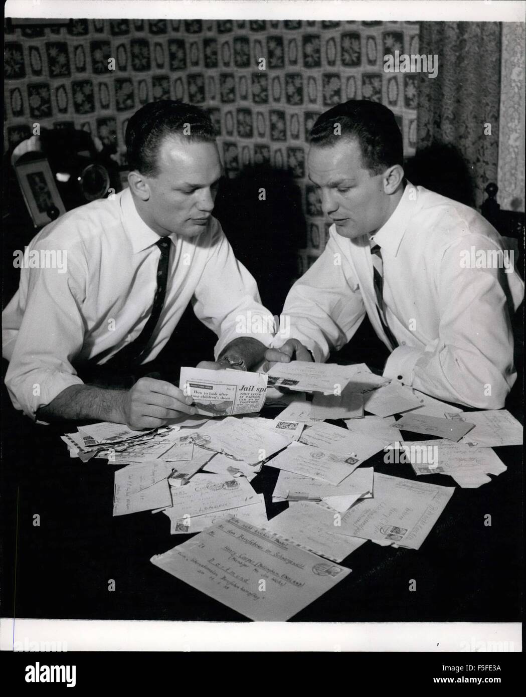 1967 - Henry Cooper, assisted by his twin brother, George, answers fan ...