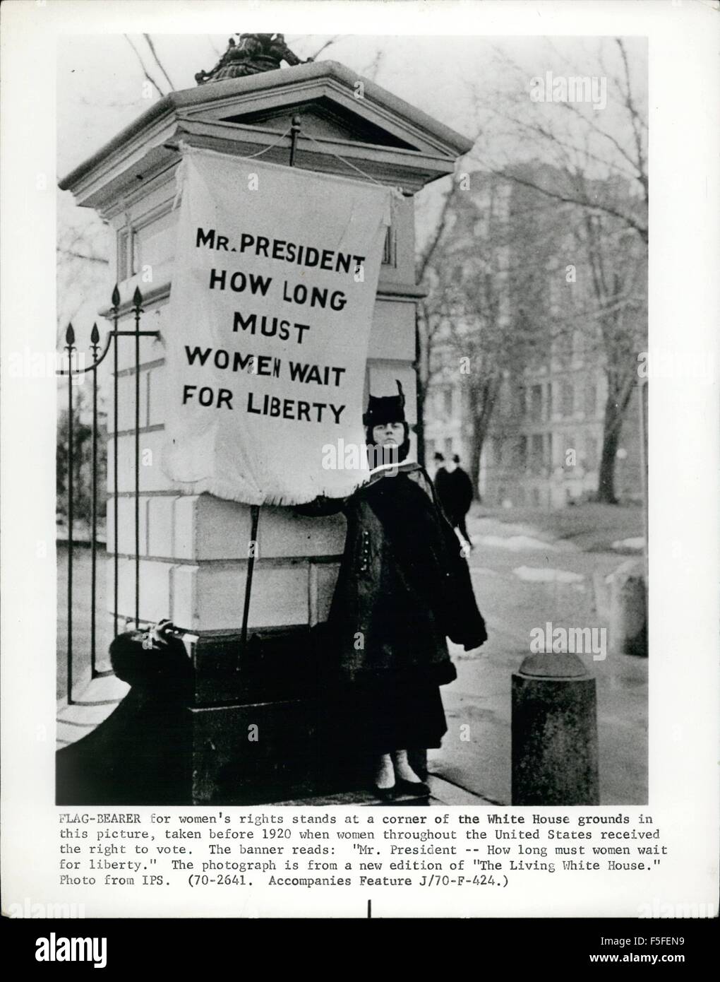 1967 - Flag-Bearer for women's rights stands at a corner of the white ...