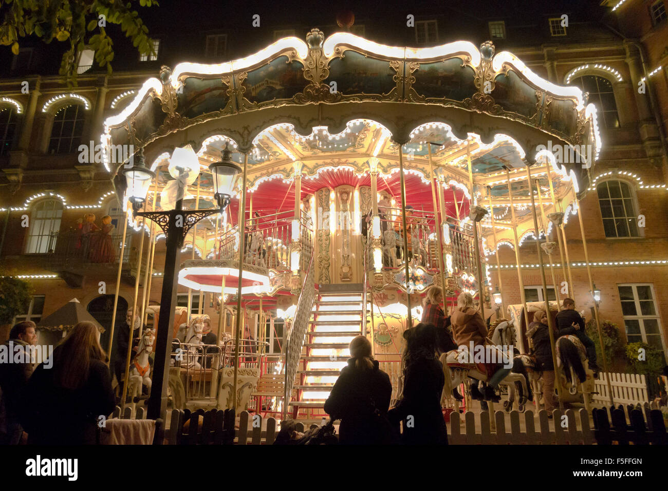Brightly lit carousel on a dark Halloween night in the Tivoli Gardens ...