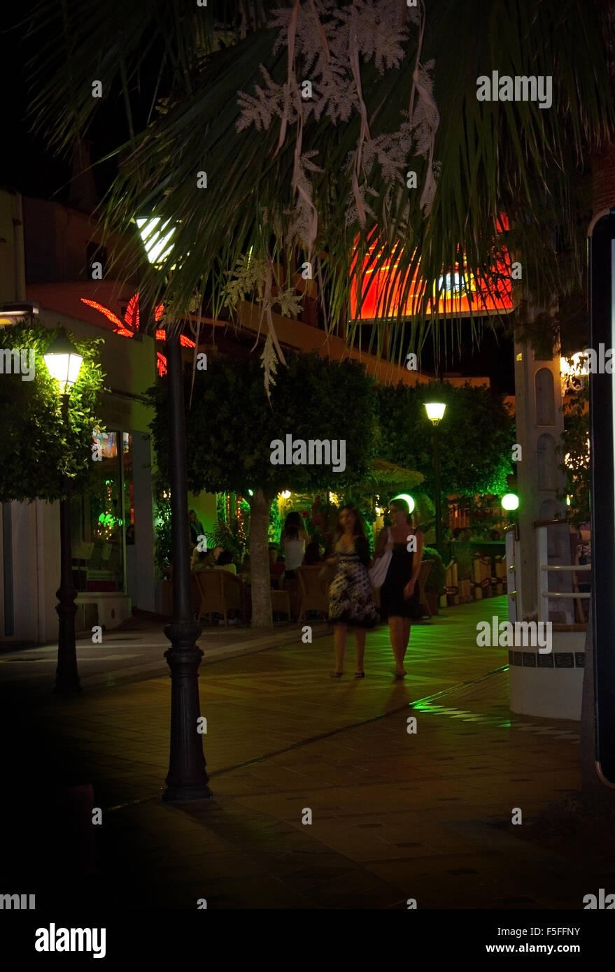 Cala d'Or pedestrian street with brilliant lights among restaurants and ...