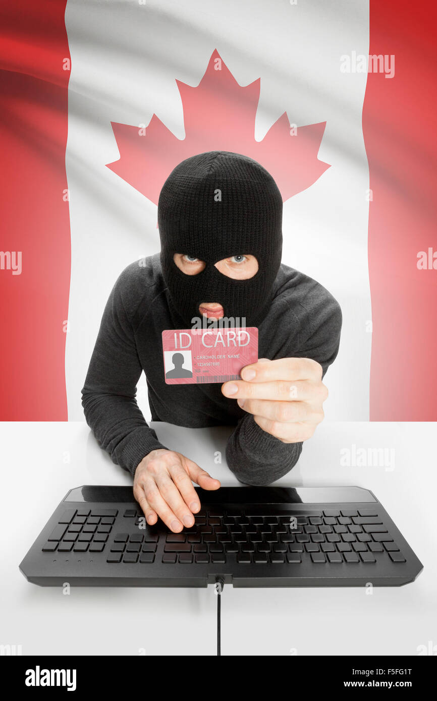 Hacker with ID card in hand and flag on background - Canada Stock Photo ...