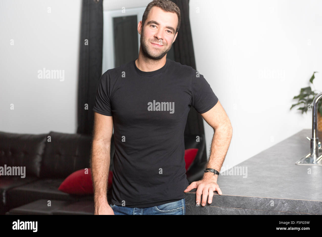 Portrait of happy young man at home Stock Photo - Alamy