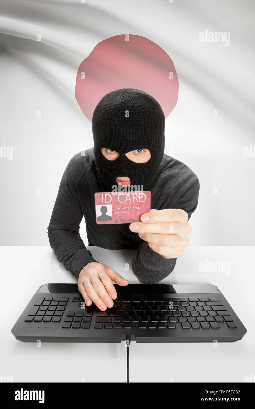 Hacker with ID card in hand and flag on background - Japan Stock Photo ...