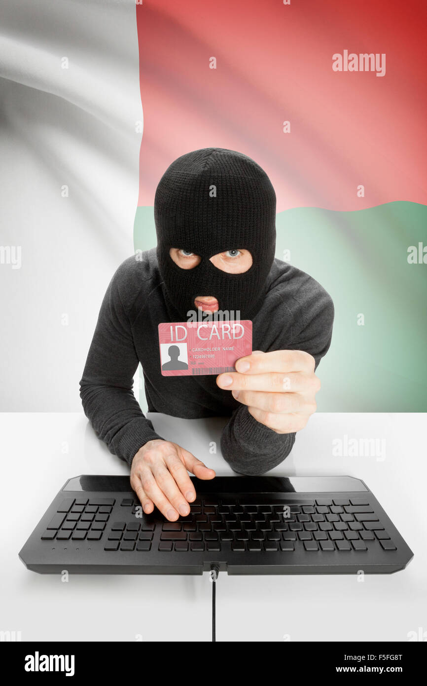 Hacker with ID card in hand and flag on background - Madagascar Stock ...