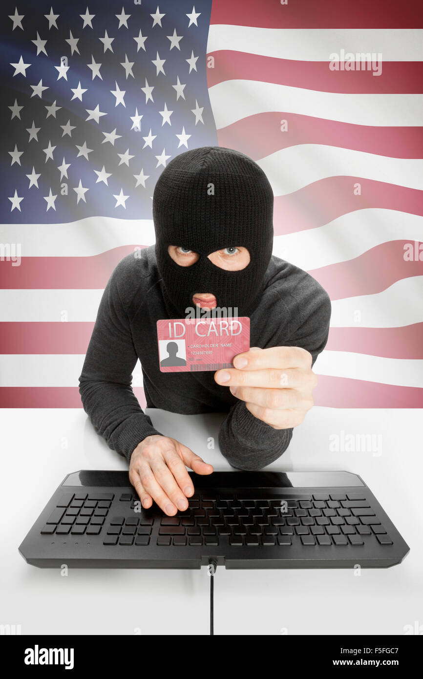 Hacker with ID card in hand and flag on background - United States ...