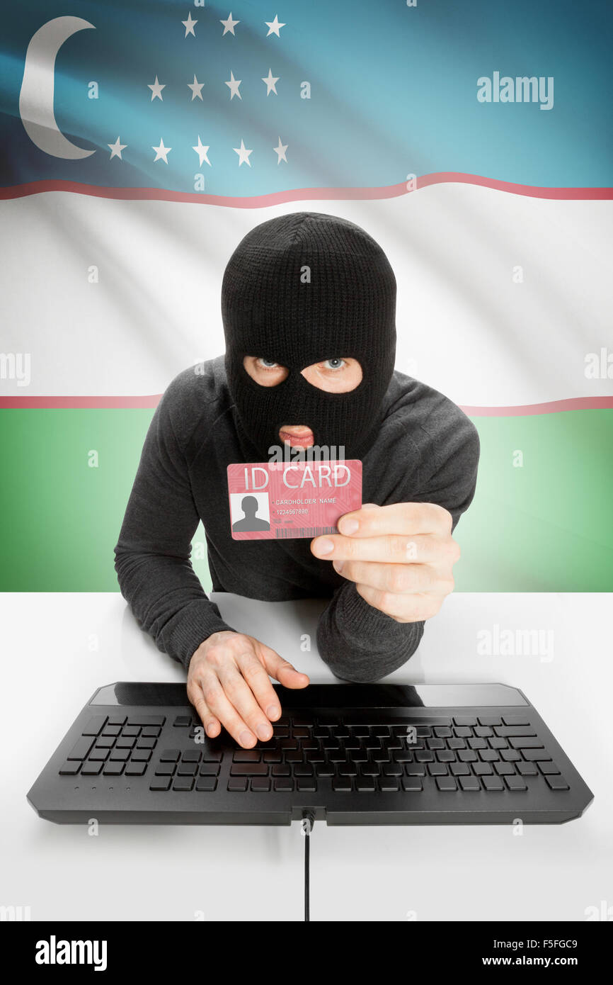 Hacker with ID card in hand and flag on background - Uzbekistan Stock ...