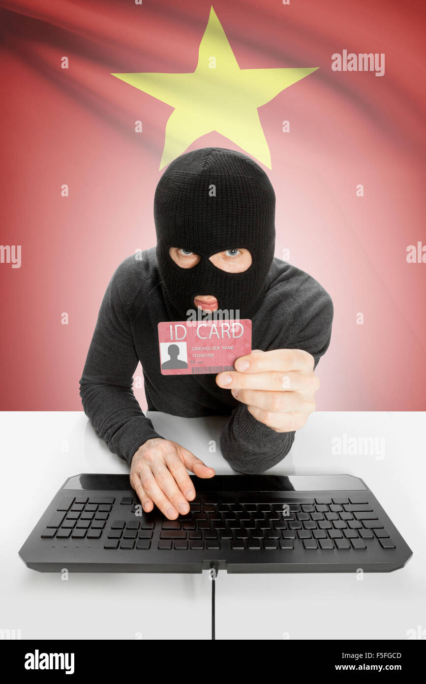 Hacker with ID card in hand and flag on background - Vietnam Stock ...