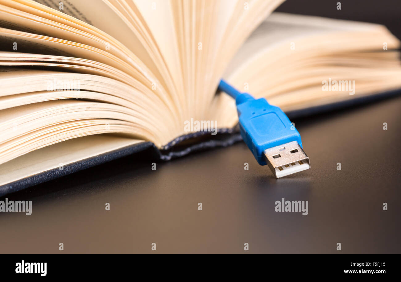 Usb cable sticks out from a book Stock Photo - Alamy