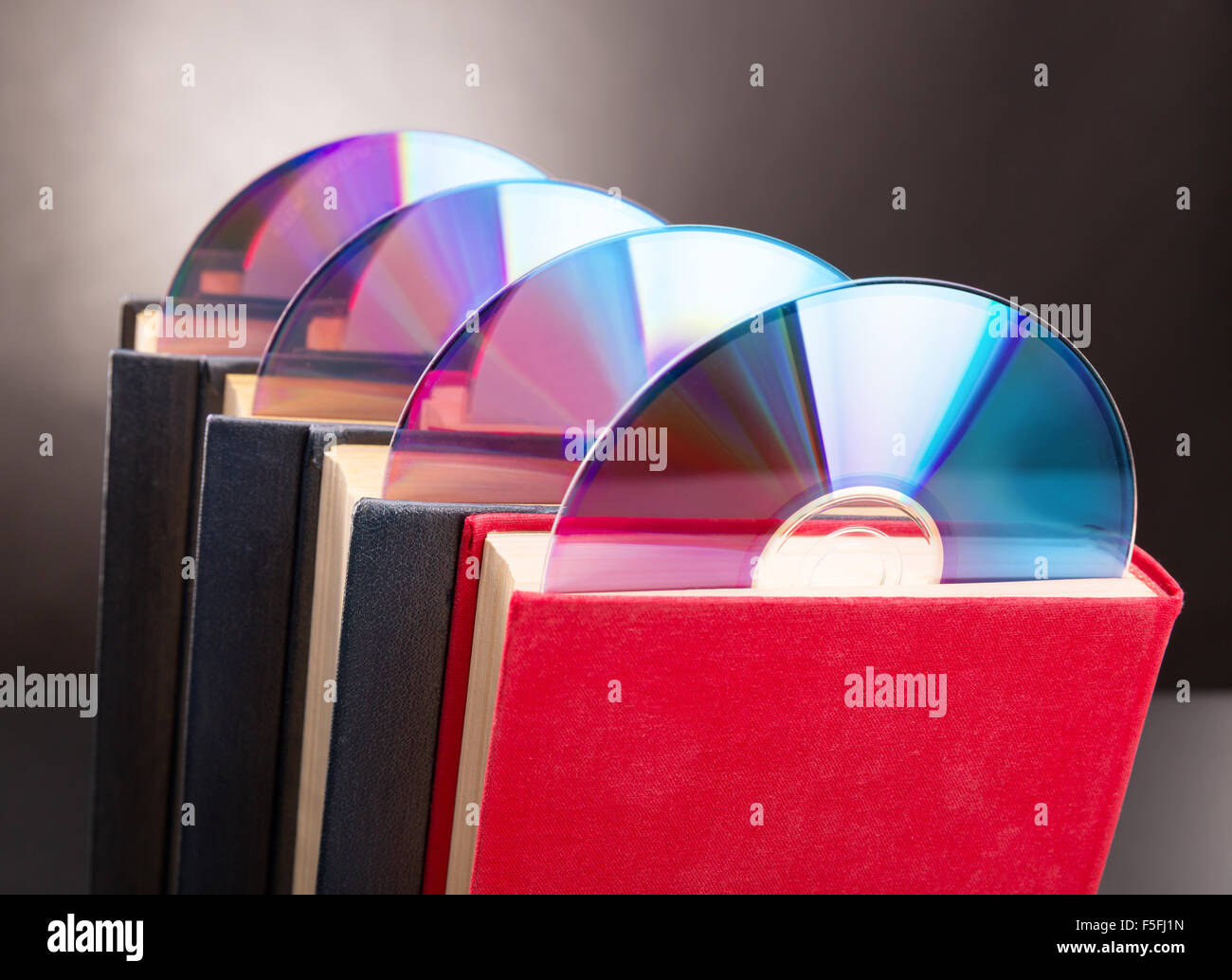 Cd disks are sticks out from red book Stock Photo - Alamy