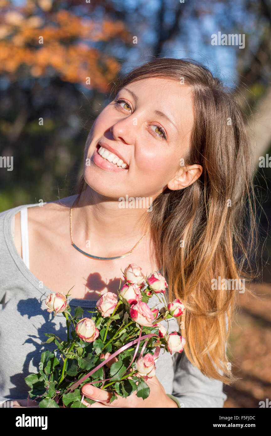 Portrait smiling girl holding roses hi-res stock photography and images ...