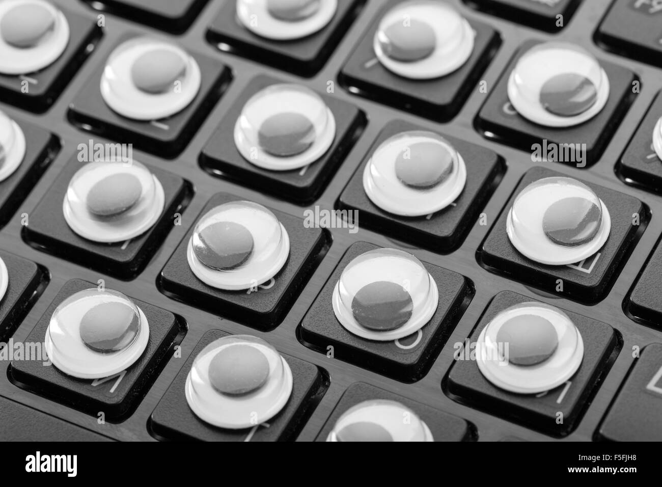 Close up keyboard with eyes instead of buttons Stock Photo - Alamy