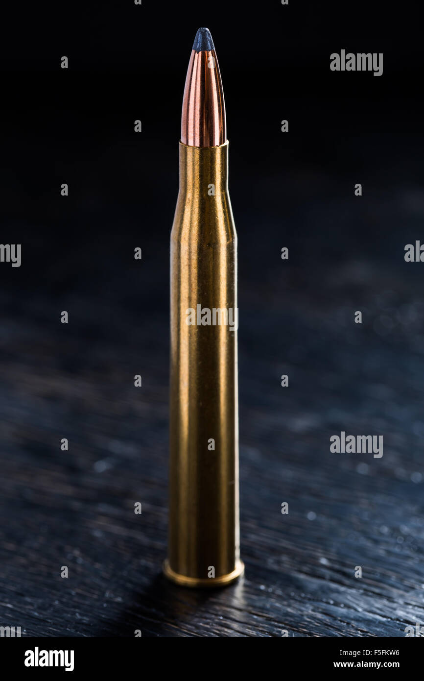 Large-caliber cartridge on a dark background Stock Photo - Alamy