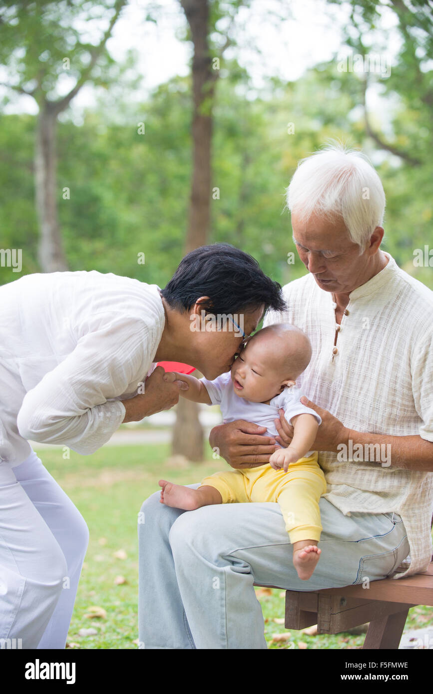 chinese grandfather and grandmother playing with baby grandson at ...