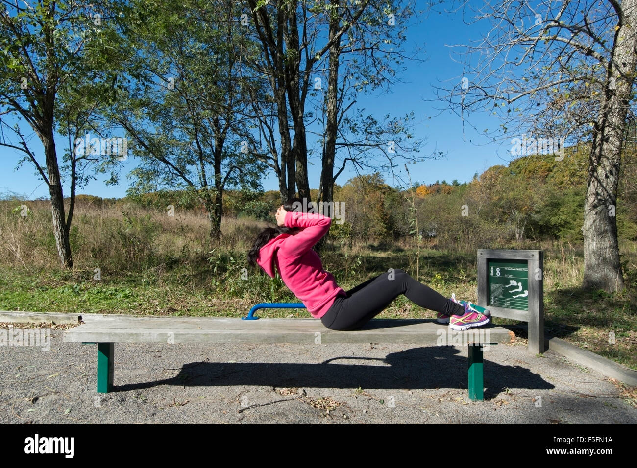 Middle-aged woman exercising on the Teresa and Roberta Lee Fitness path ...
