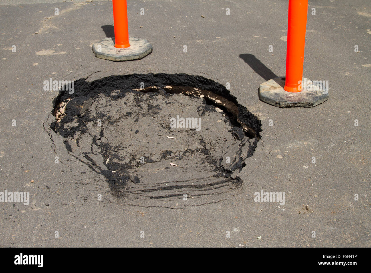 Broken asphalt pavement caused by rain and subsidence due to a lack of ...