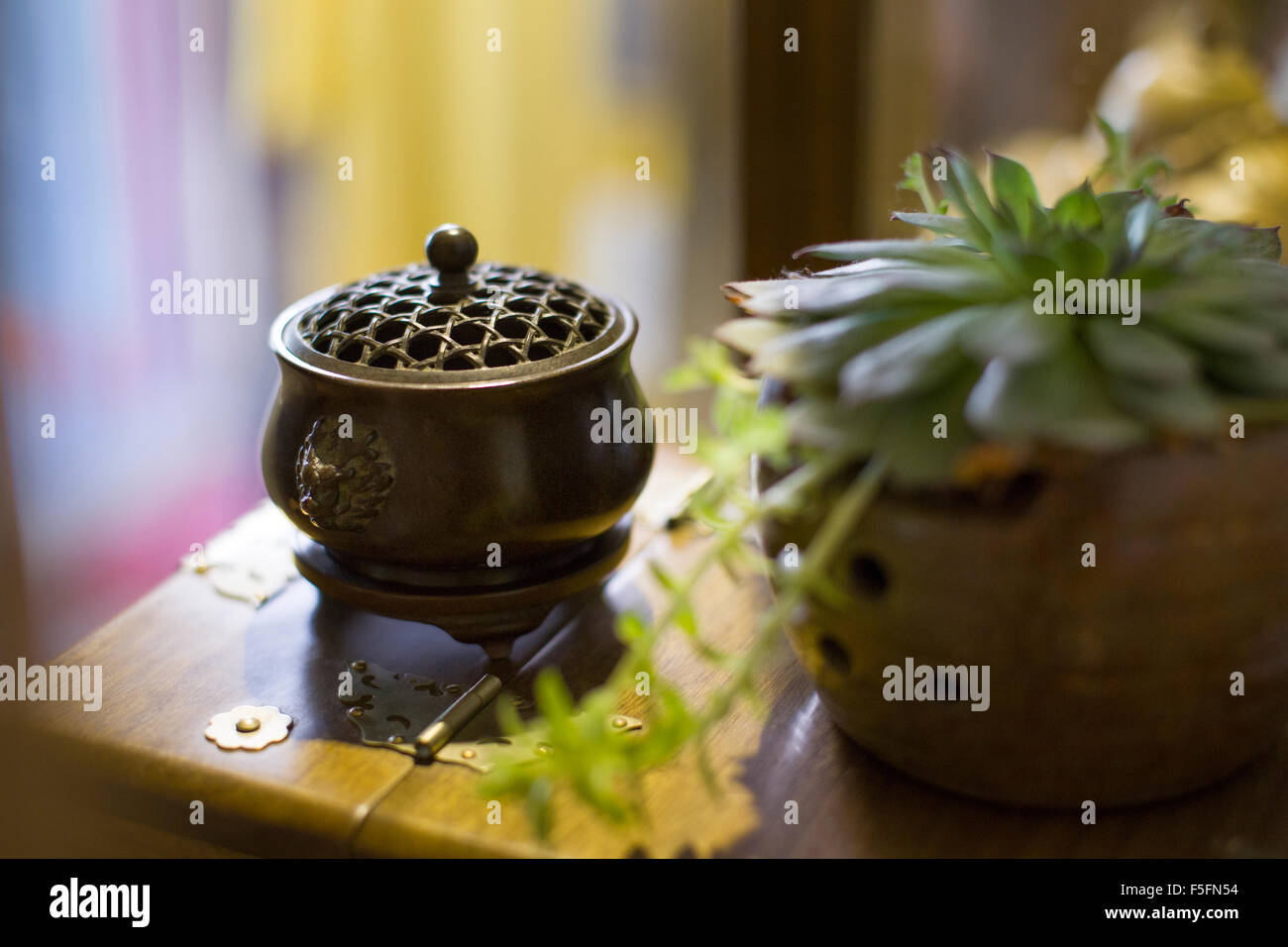 Traditional Chinese censer and potted plant Stock Photo - Alamy