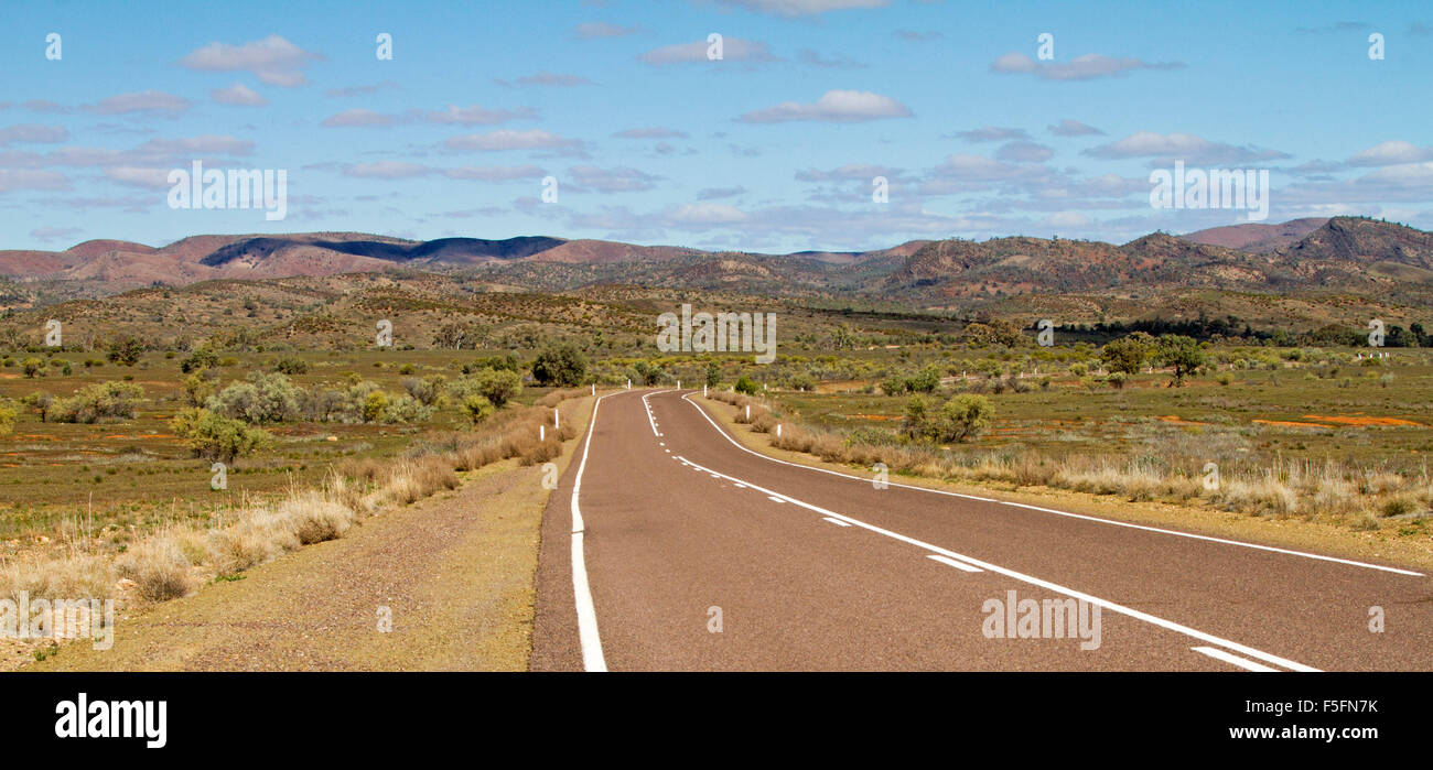 Panoramic view of highway slicing through vast outback landscape ...