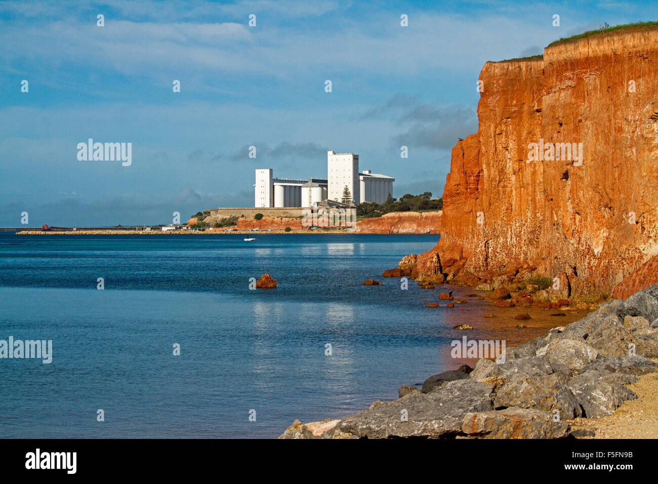Huge white grain silos at Port Giles, on red coastal cliffs beside ...
