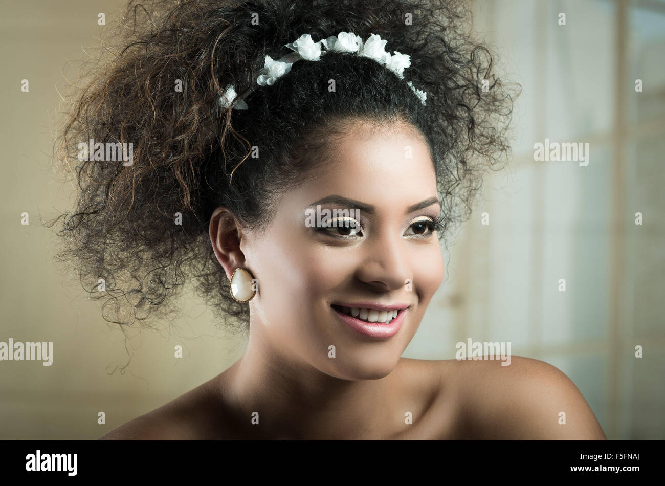 Closeup portrait of beautiful hispanic young woman with curly hair ...
