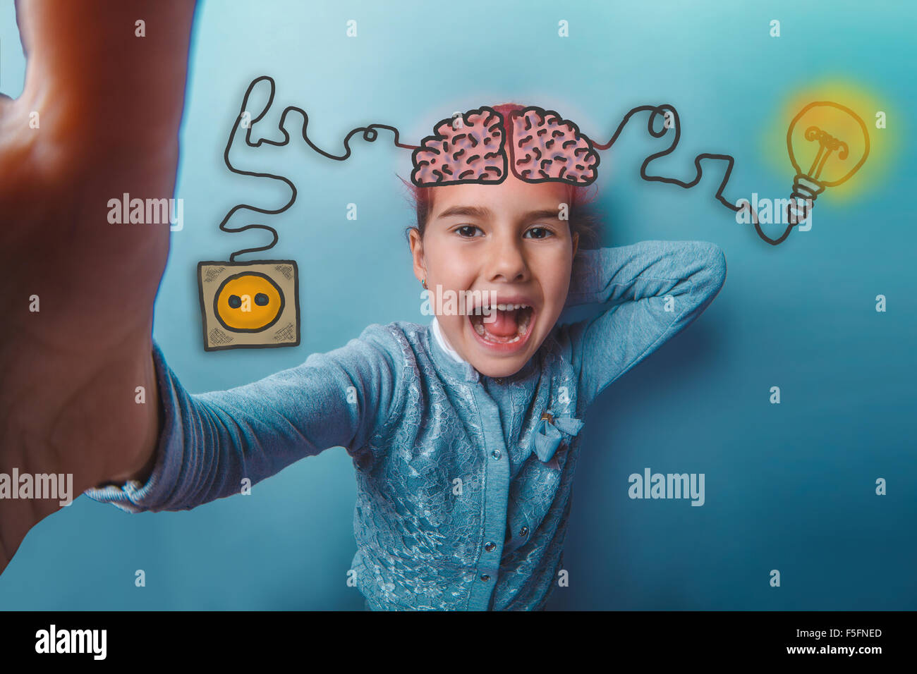 baby girl laughing close up photo makes the charging cord plug w Stock ...