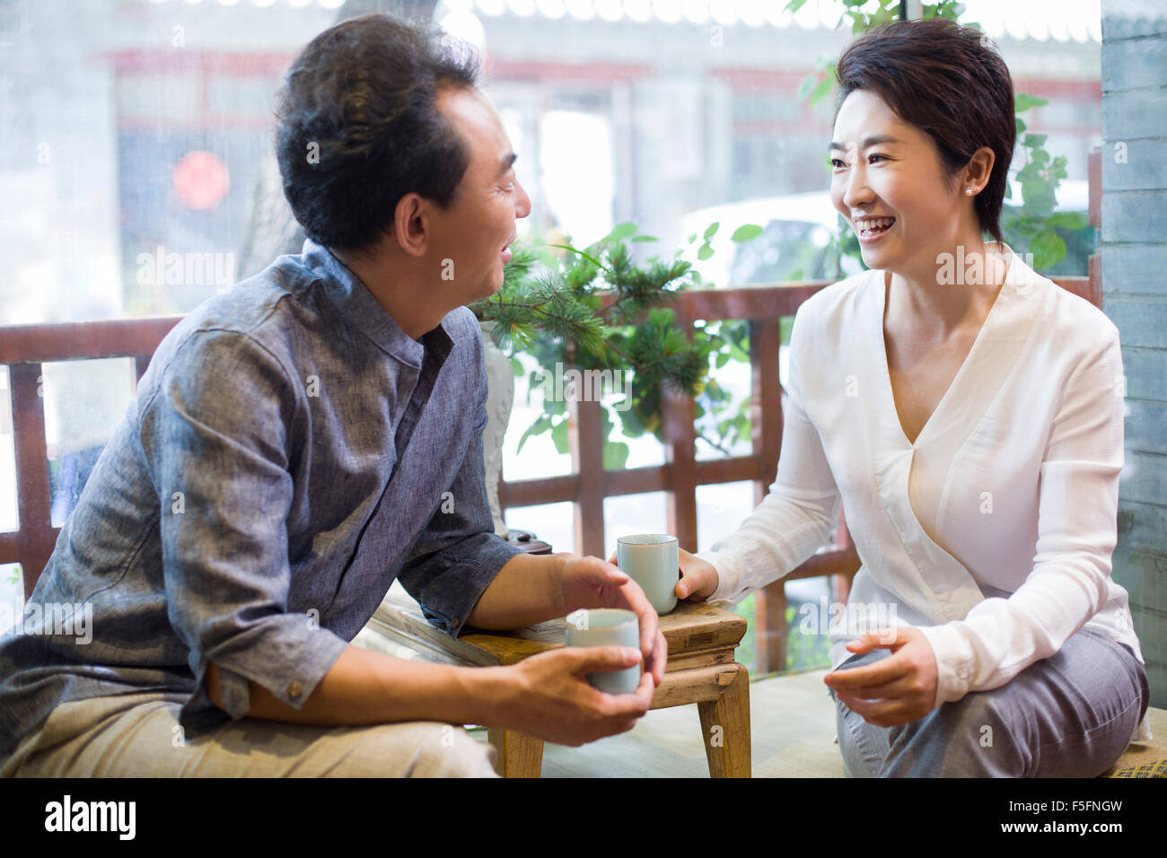 Friends drinking tea and talking in tea room Stock Photo - Alamy