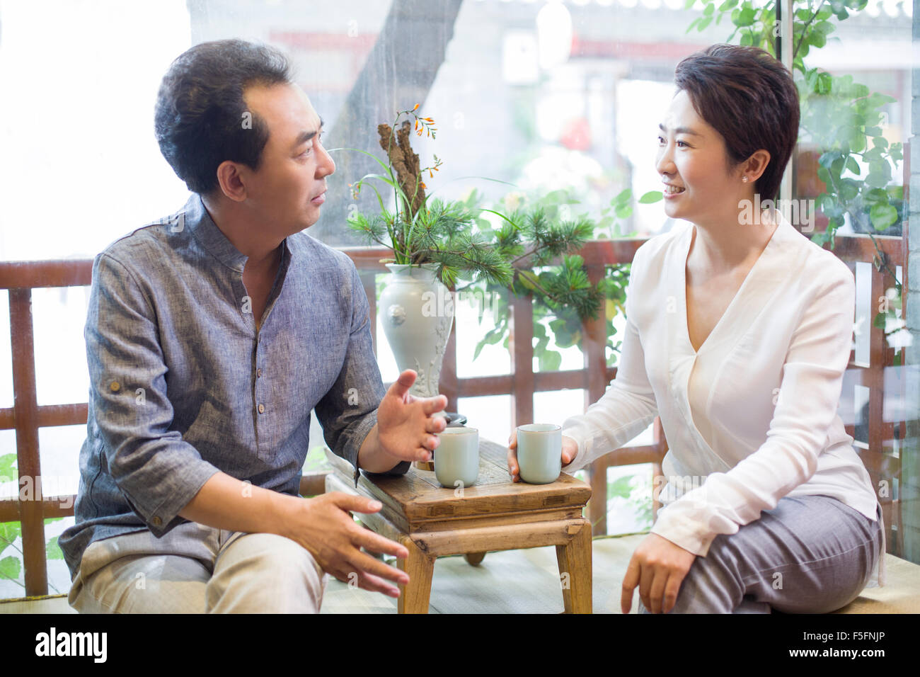 Friends drinking tea and talking in tea room Stock Photo - Alamy