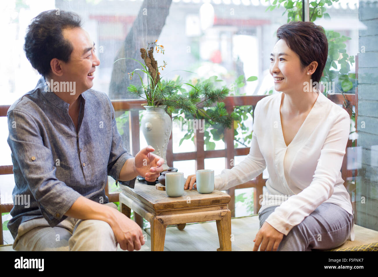 Friends drinking tea and talking in tea room Stock Photo - Alamy