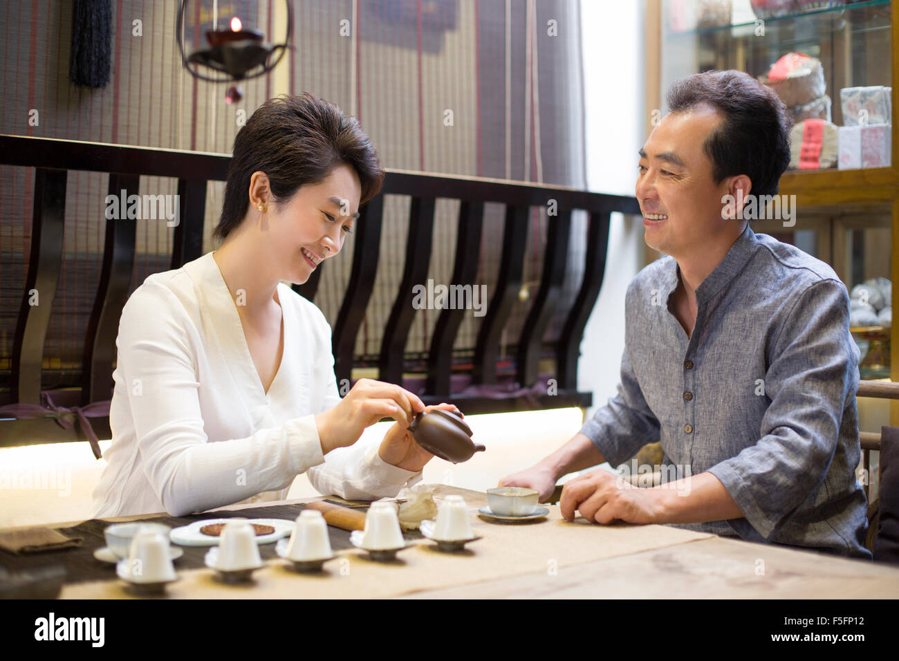 Friends drinking tea and talking in tea room Stock Photo - Alamy
