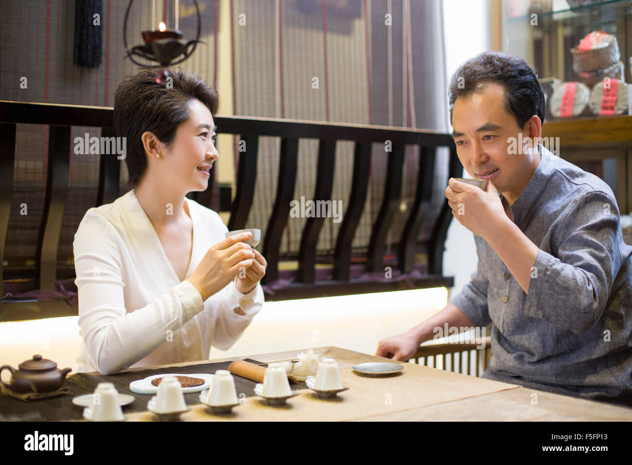 Friends drinking tea and talking in tea room Stock Photo - Alamy