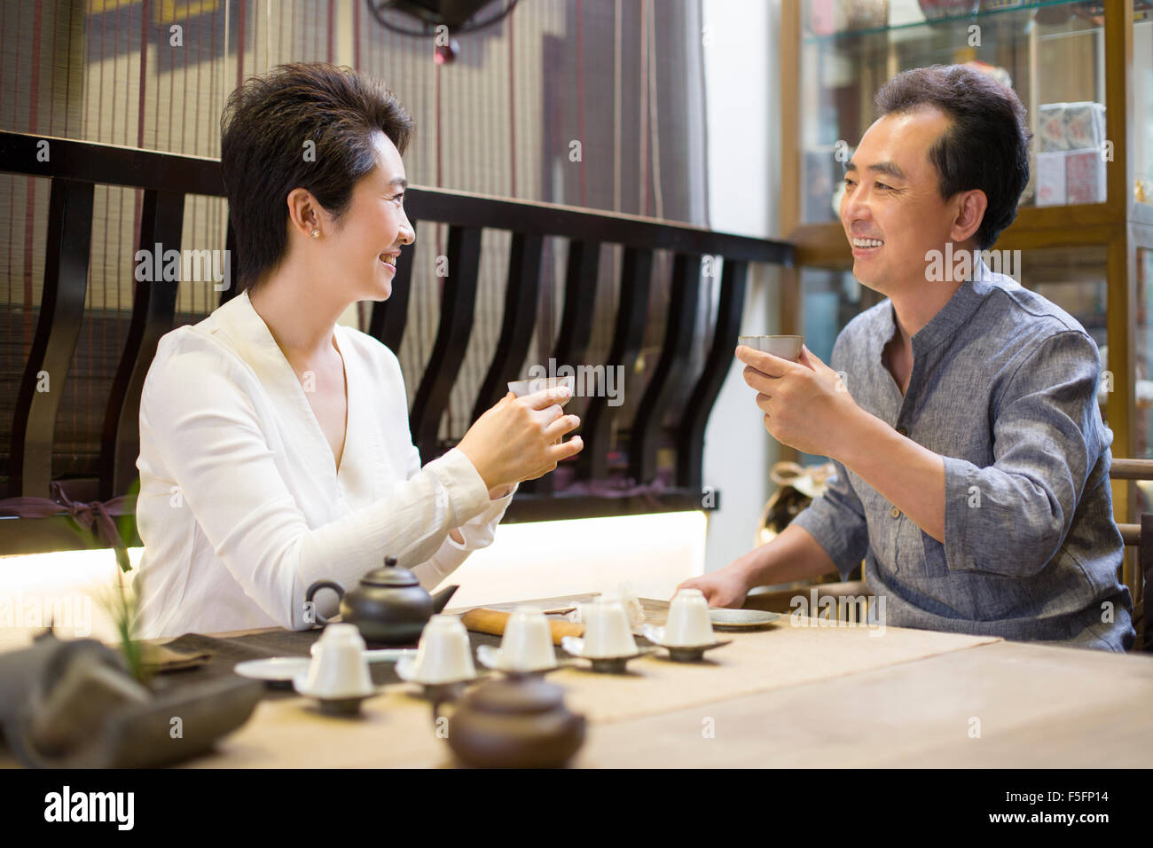 Friends drinking tea and talking in tea room Stock Photo - Alamy