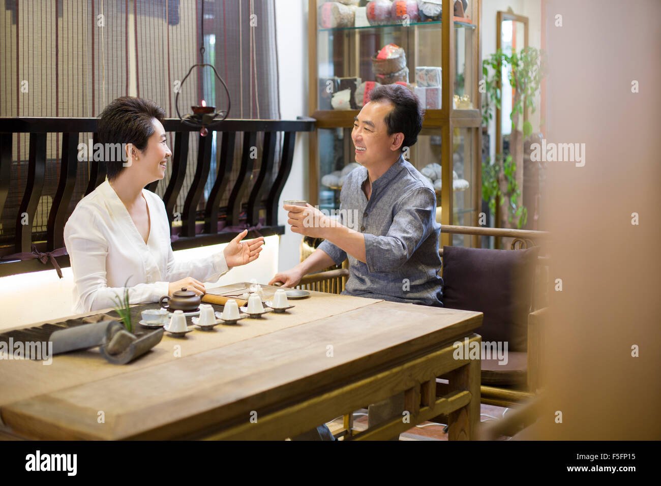 Friends drinking tea and talking in tea room Stock Photo - Alamy