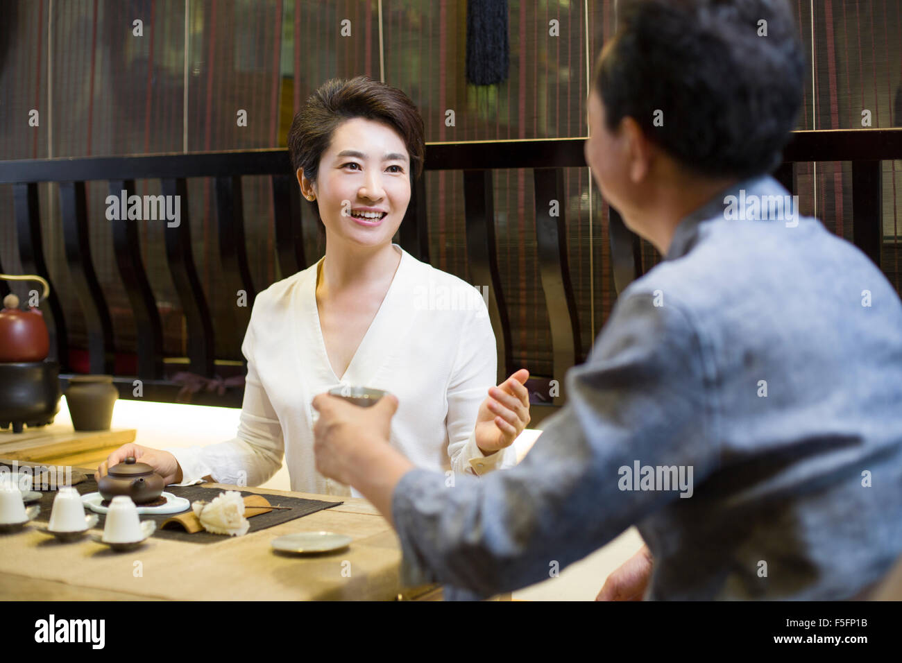 Friends drinking tea and talking in tea room Stock Photo - Alamy