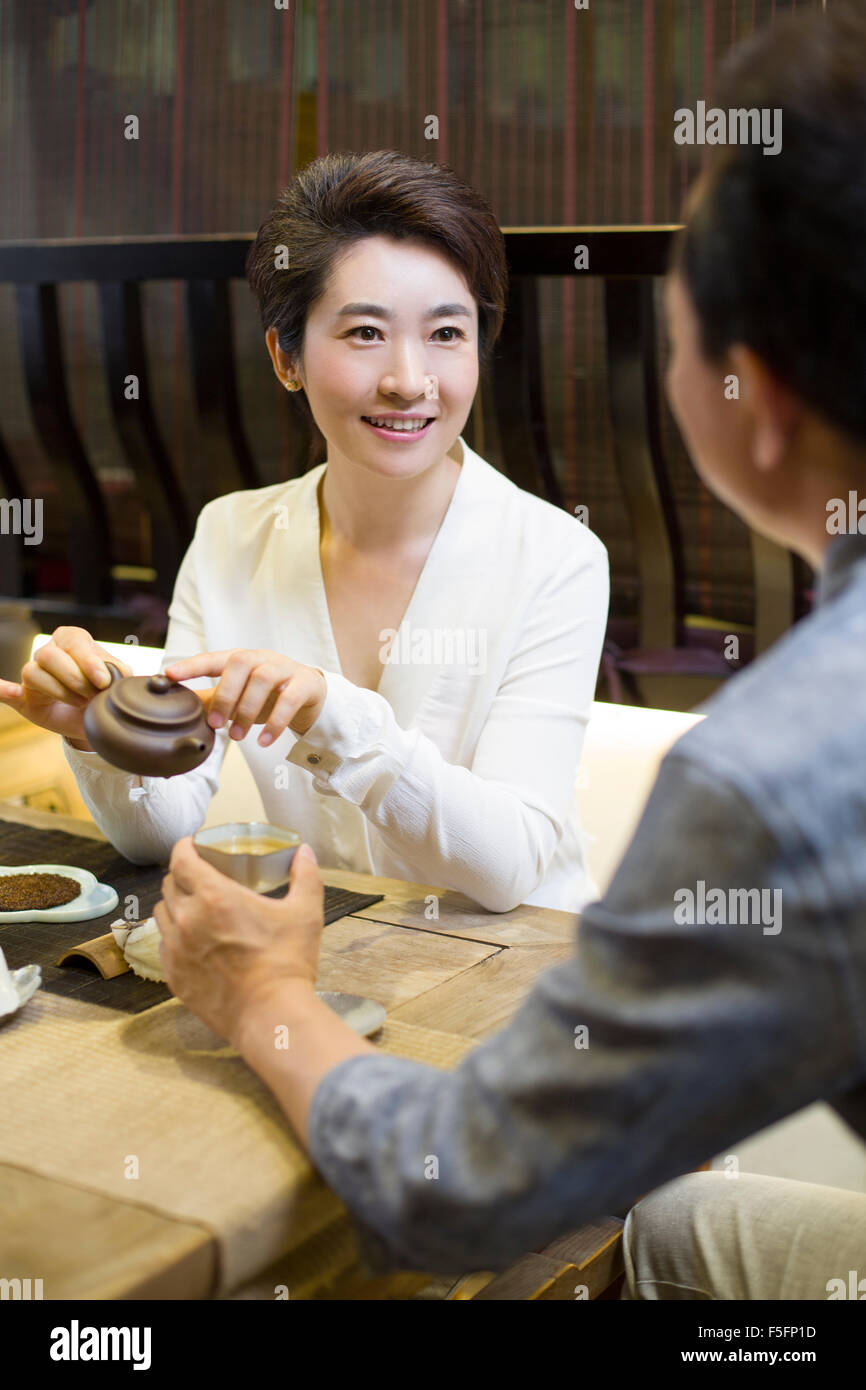 Friends drinking tea and talking in tea room Stock Photo - Alamy