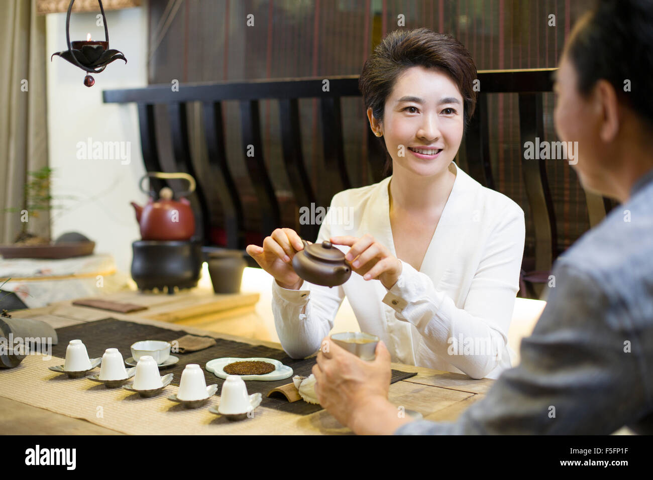 Friends drinking tea and talking in tea room Stock Photo - Alamy