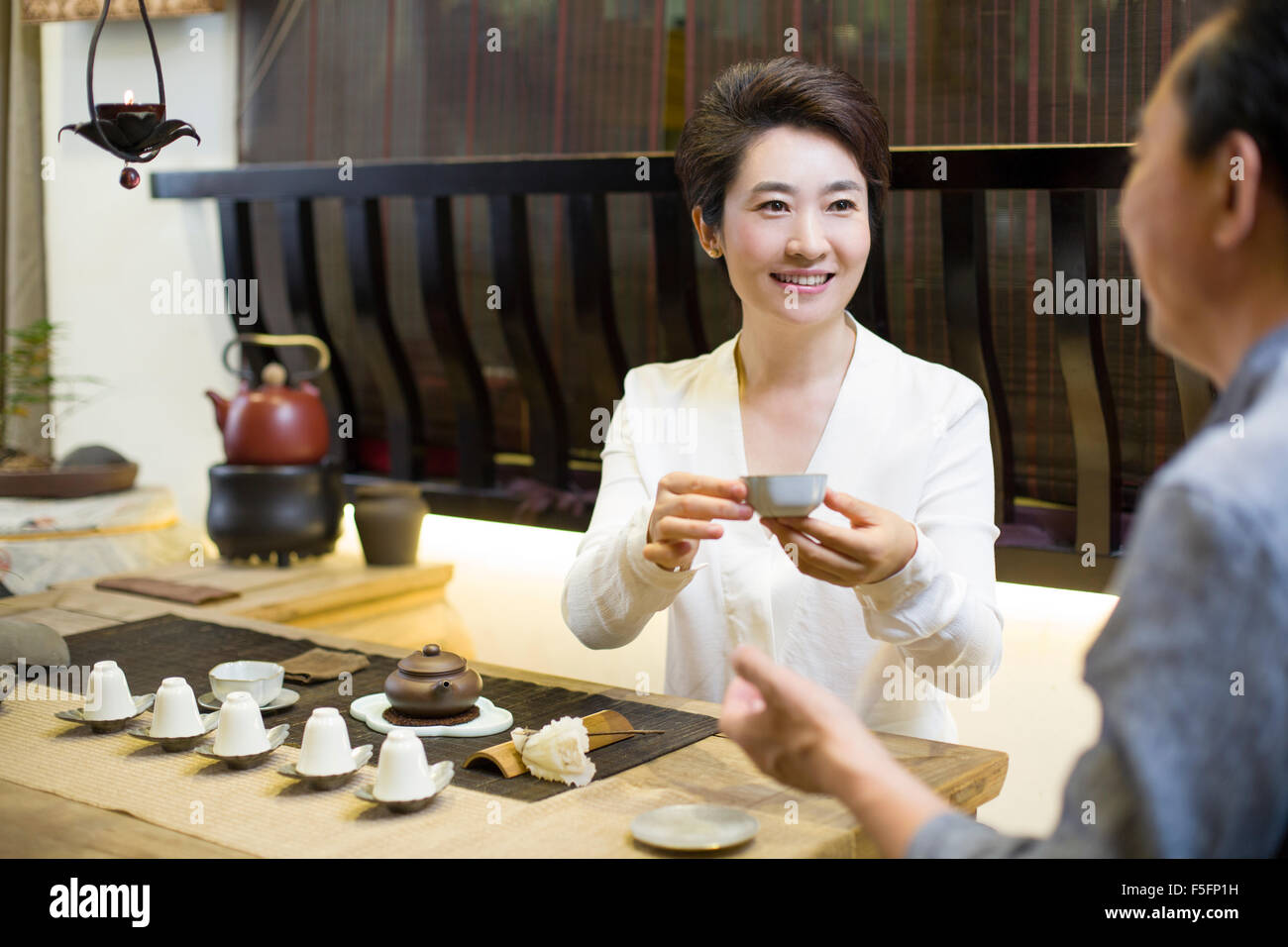 Friends drinking tea and talking in tea room Stock Photo - Alamy