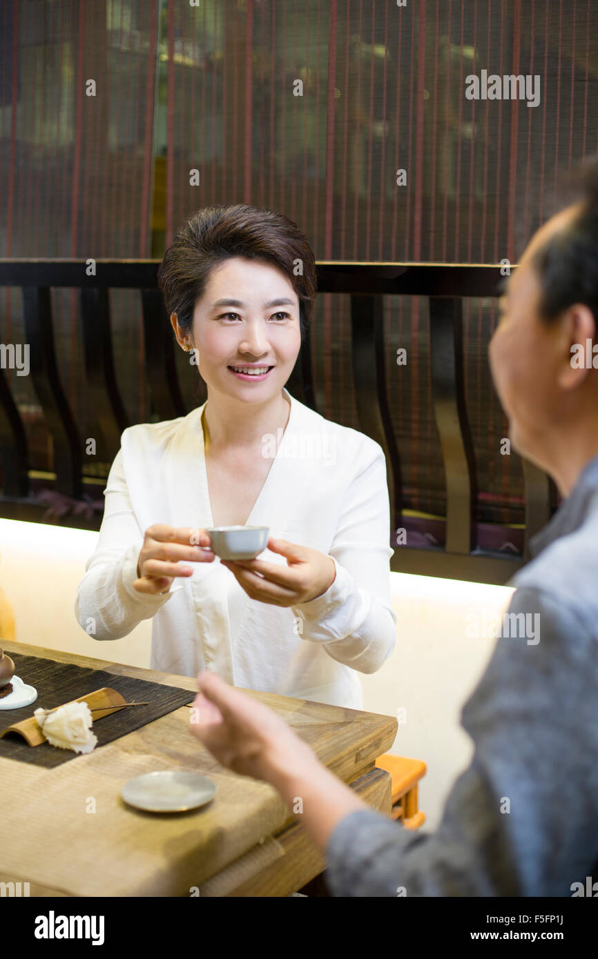 Friends drinking tea and talking in tea room Stock Photo - Alamy