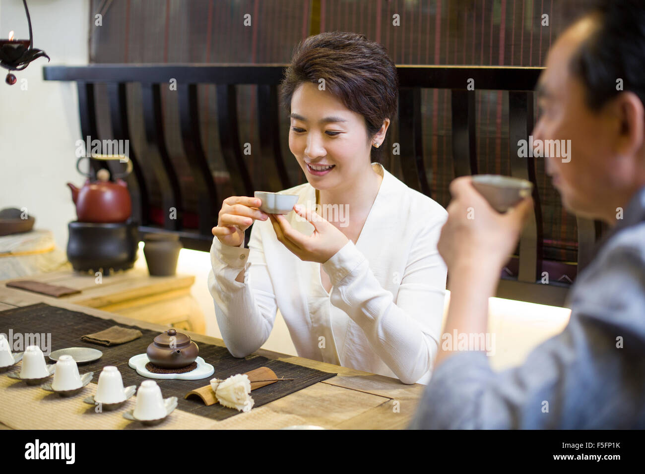 Friends drinking tea and talking in tea room Stock Photo - Alamy