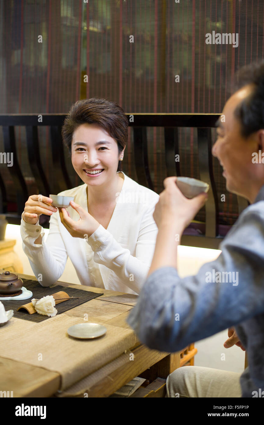 Friends drinking tea and talking in tea room Stock Photo - Alamy