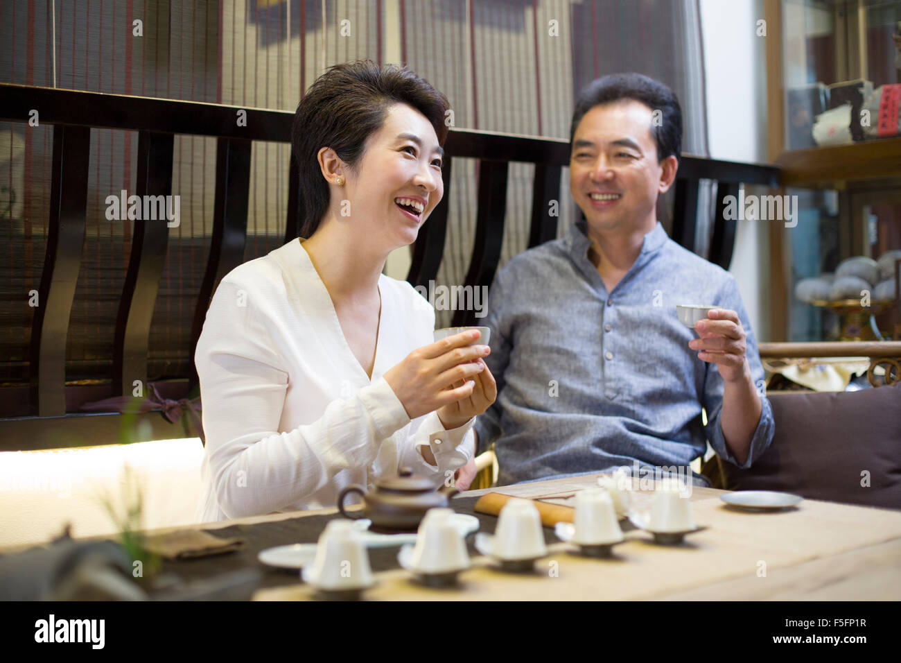 Friends drinking tea and talking in tea room Stock Photo - Alamy