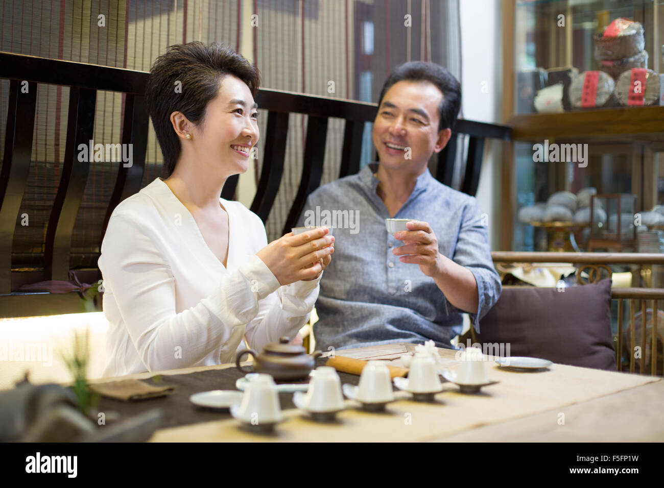 Friends drinking tea and talking in tea room Stock Photo - Alamy